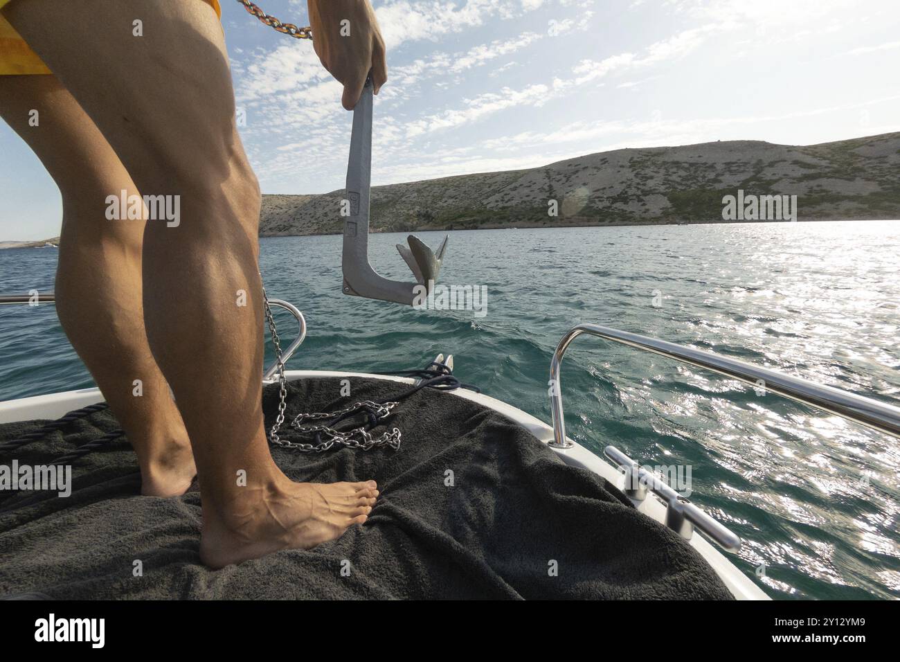Photo of a boat crew picking up the anchor from the blue and clean ...