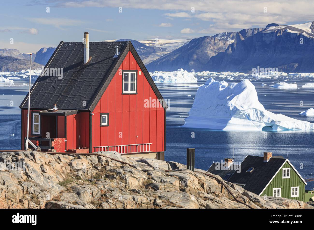 Typical Greenlandic houses in front of icebergs, Inuit settlement ...