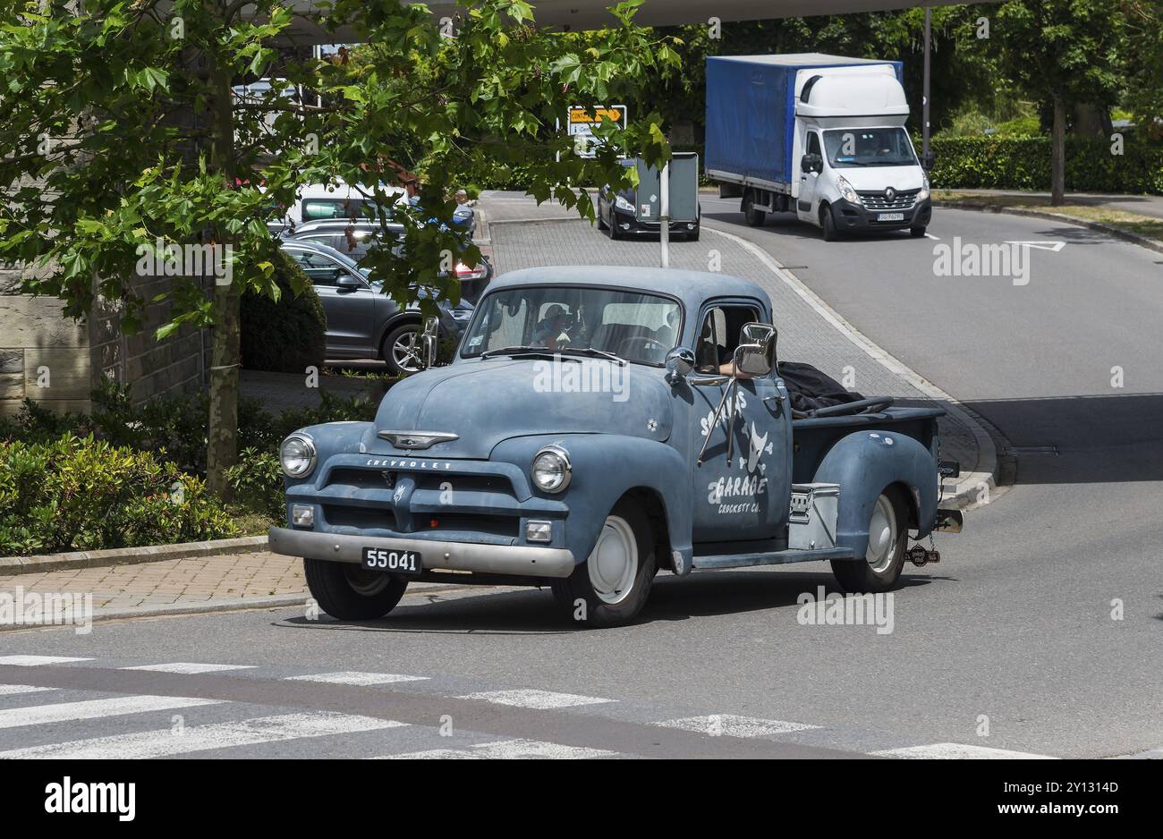 A blue vintage truck drives through an urban environment, Vintage car ...
