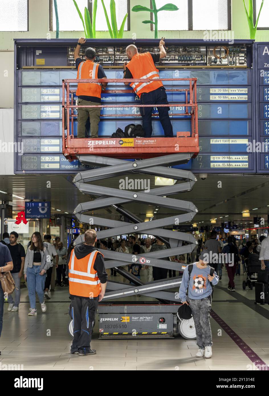 Technicians working on an electronic information board, display board ...
