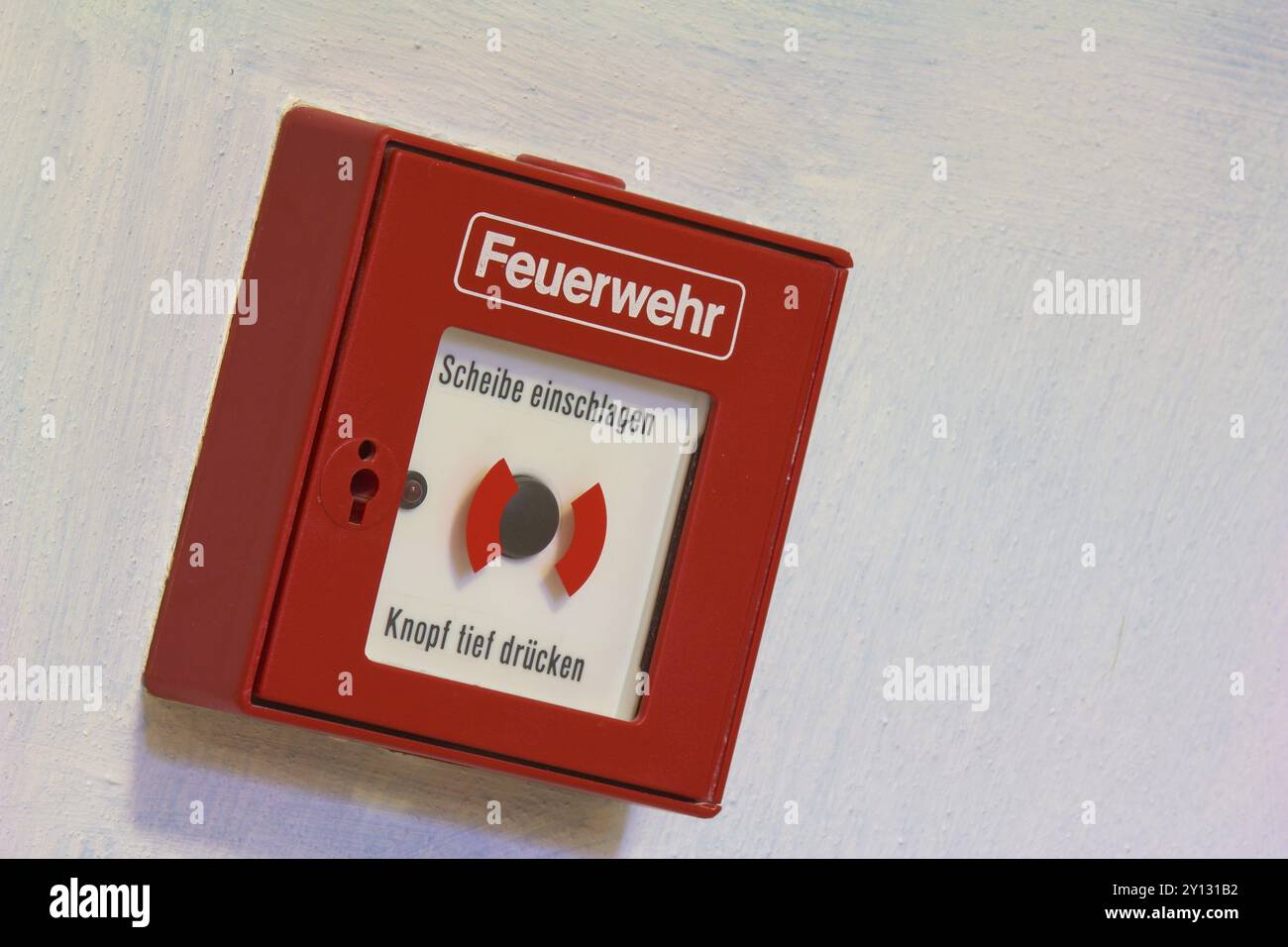 Red fire alarm of the fire brigade on the wall for building safety ...