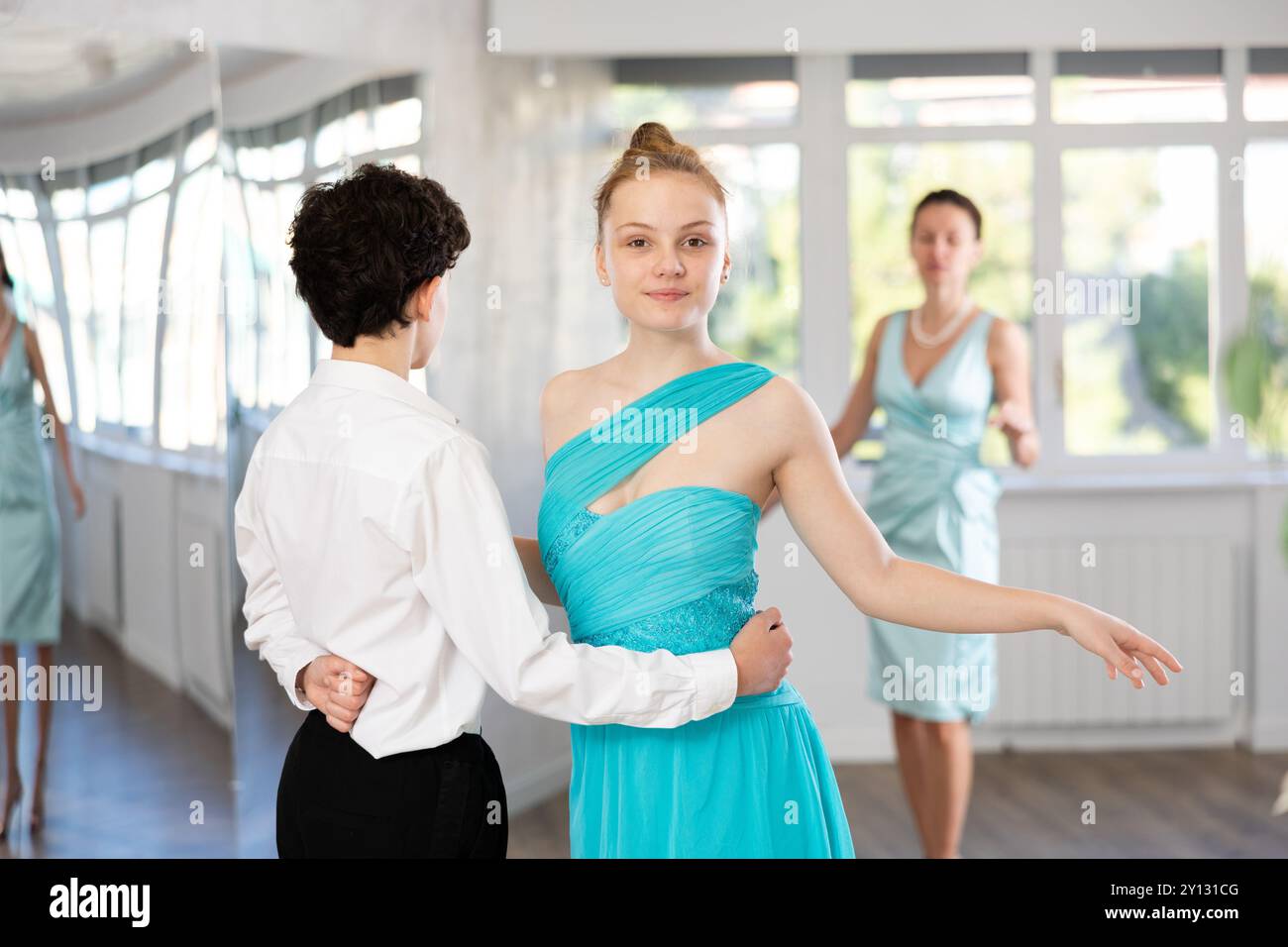 Dance teacher teaches a girl and a boy couples ballroom dancing Stock ...