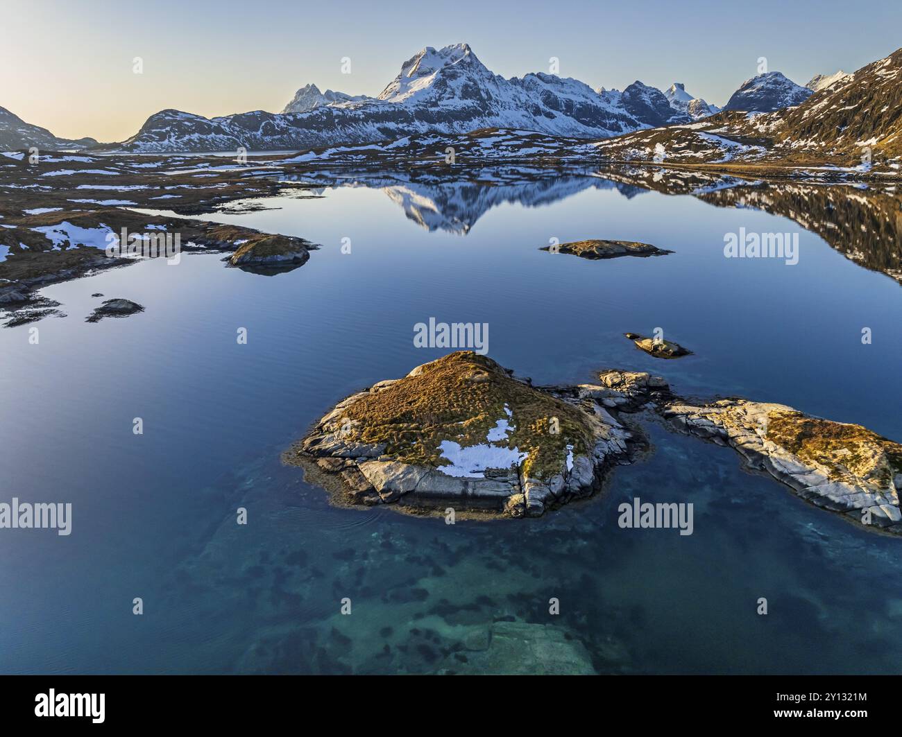Aerial view of fjord, steep mountains, coast, island, winter, morning ...