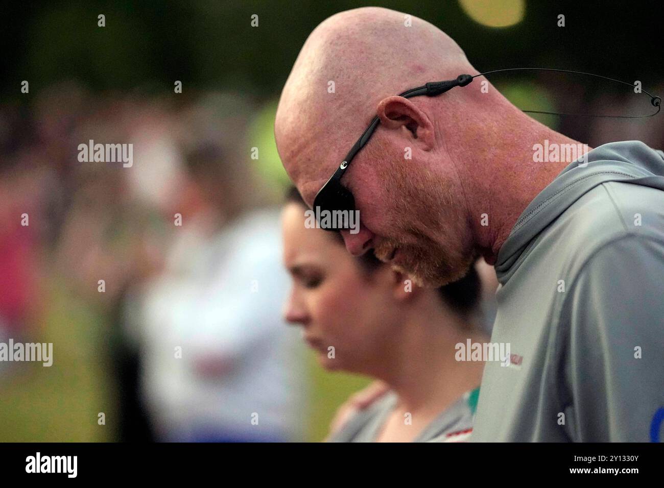 Mourners pray during a candlelight vigil for the slain students and ...