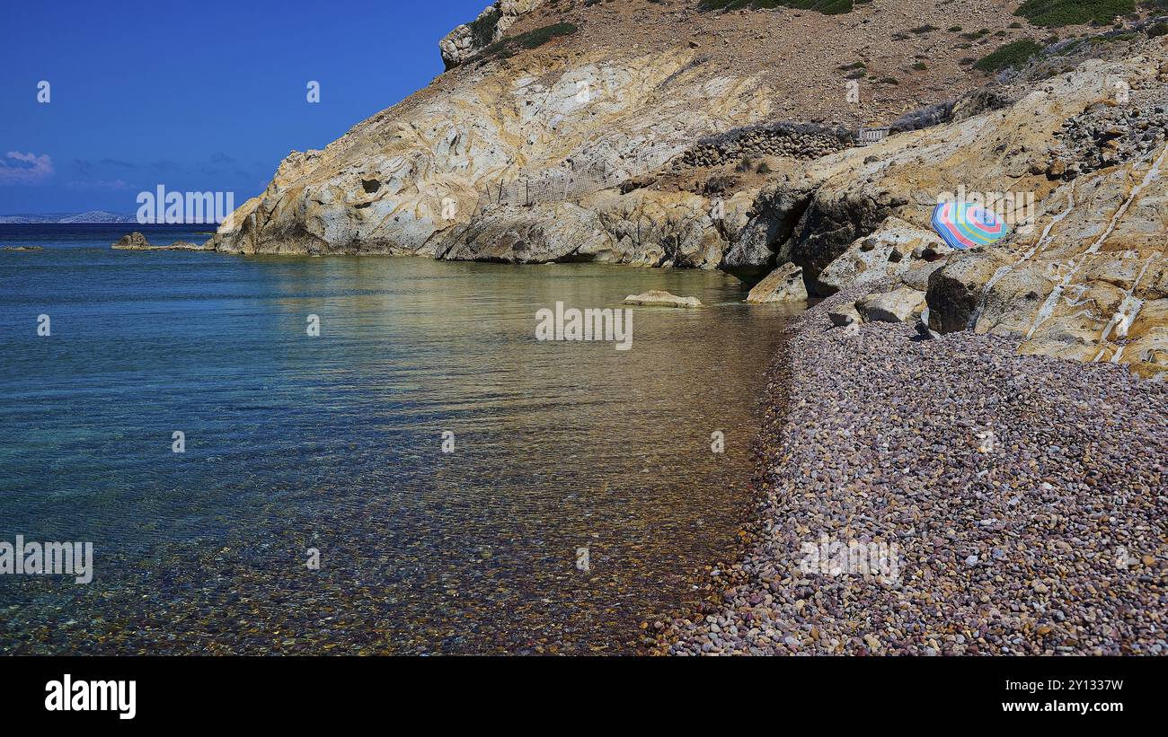 Coastal landscape with blue sea, rocky beach, imposing rock formations ...