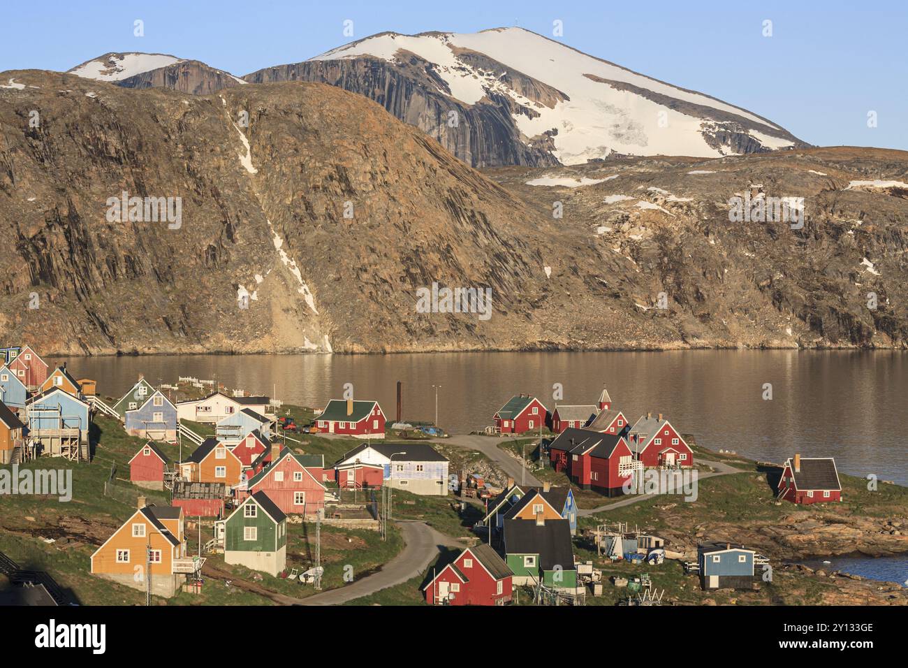 Typical Greenlandic houses in front of mountains and fjord, summer ...