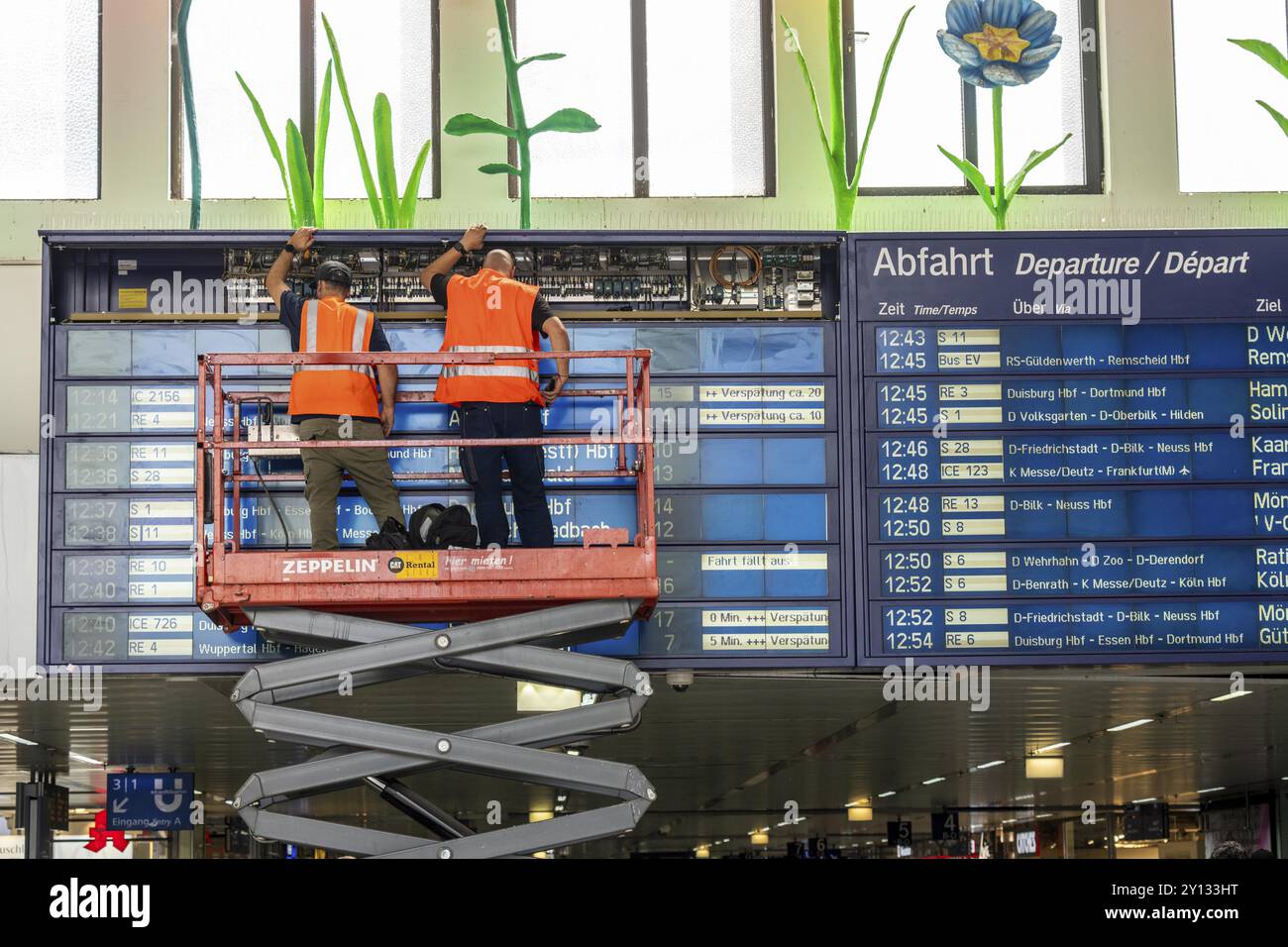 Technicians working on an electronic information board, display board ...