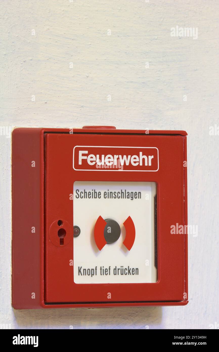 Red fire alarm of the fire brigade on the wall for building safety ...