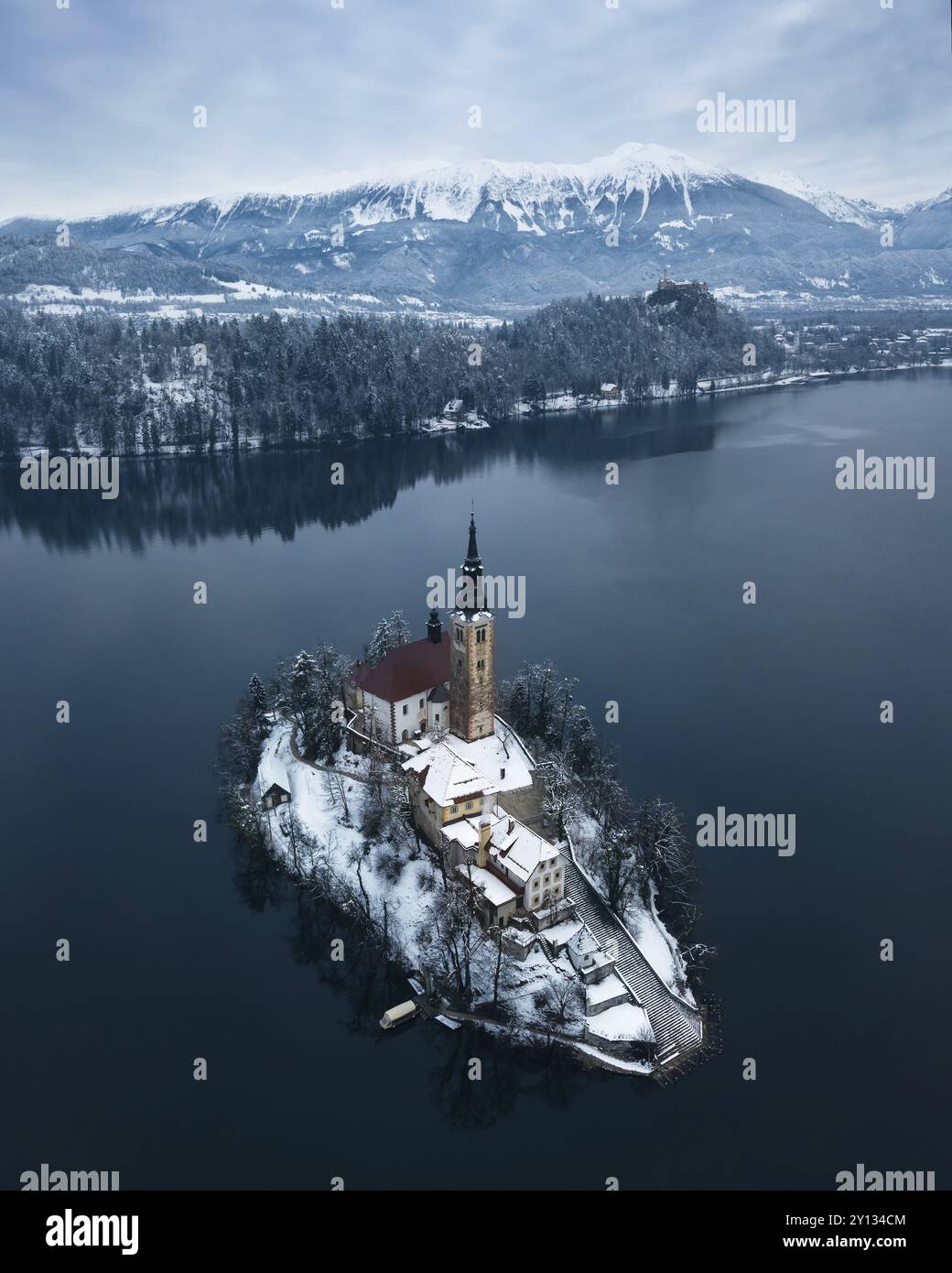 Aerial shot of lake Bled on a calm winter morning with snow Stock Photo ...