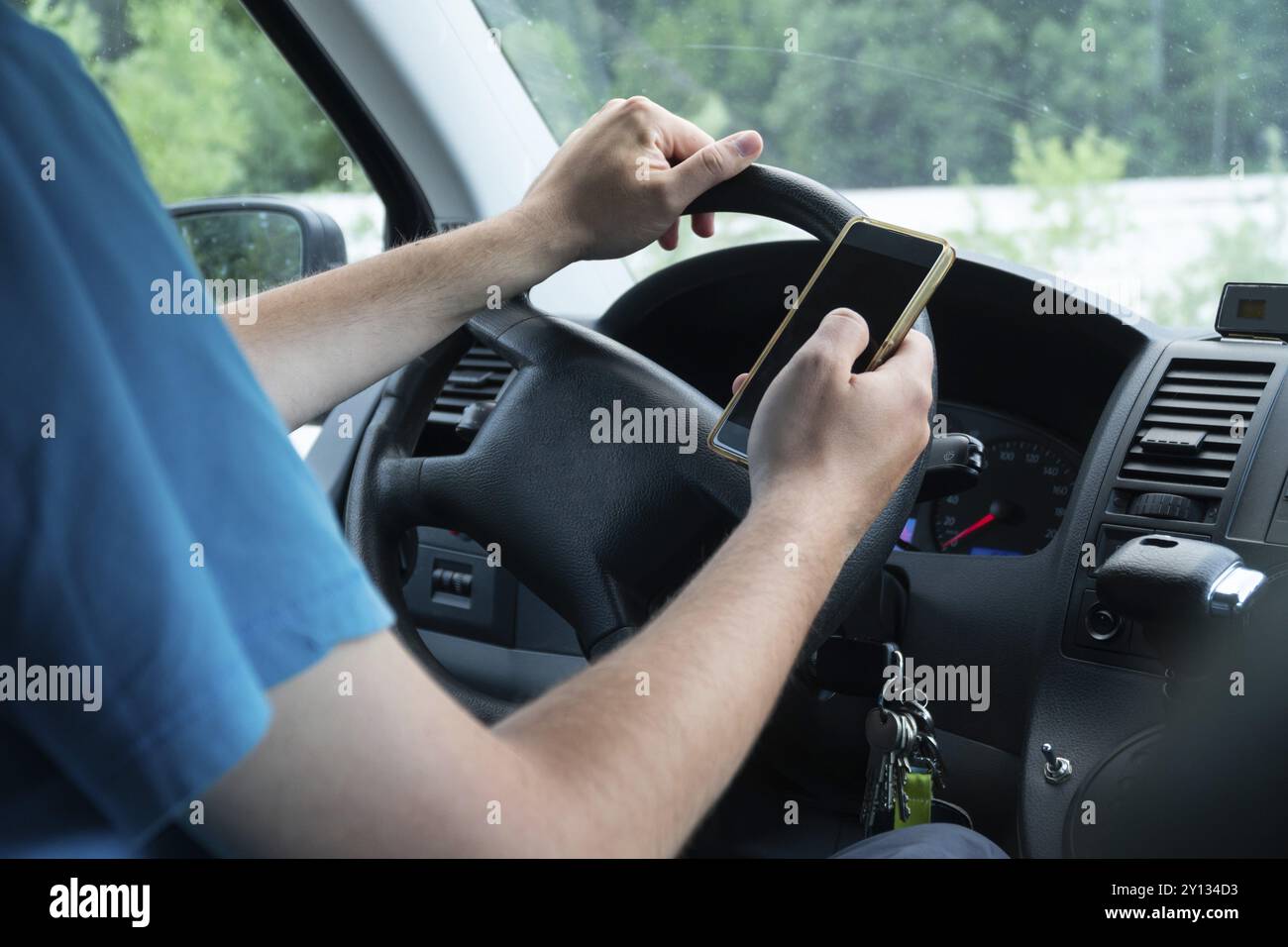 Photo of a man using smartphone while driving the car, transportation ...