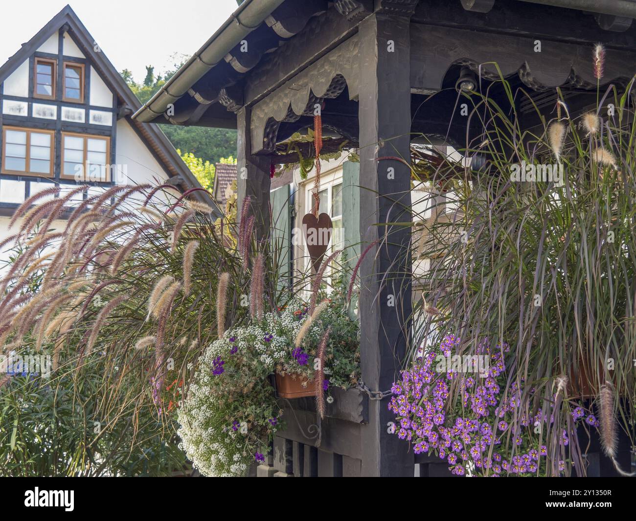 Rustic farmhouse with heart decoration and flowers on the terrace ...