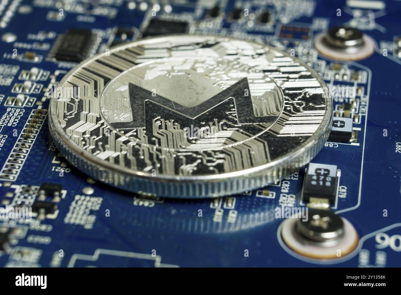Photo of A single Monero coin on the blue computer motherboard Stock ...
