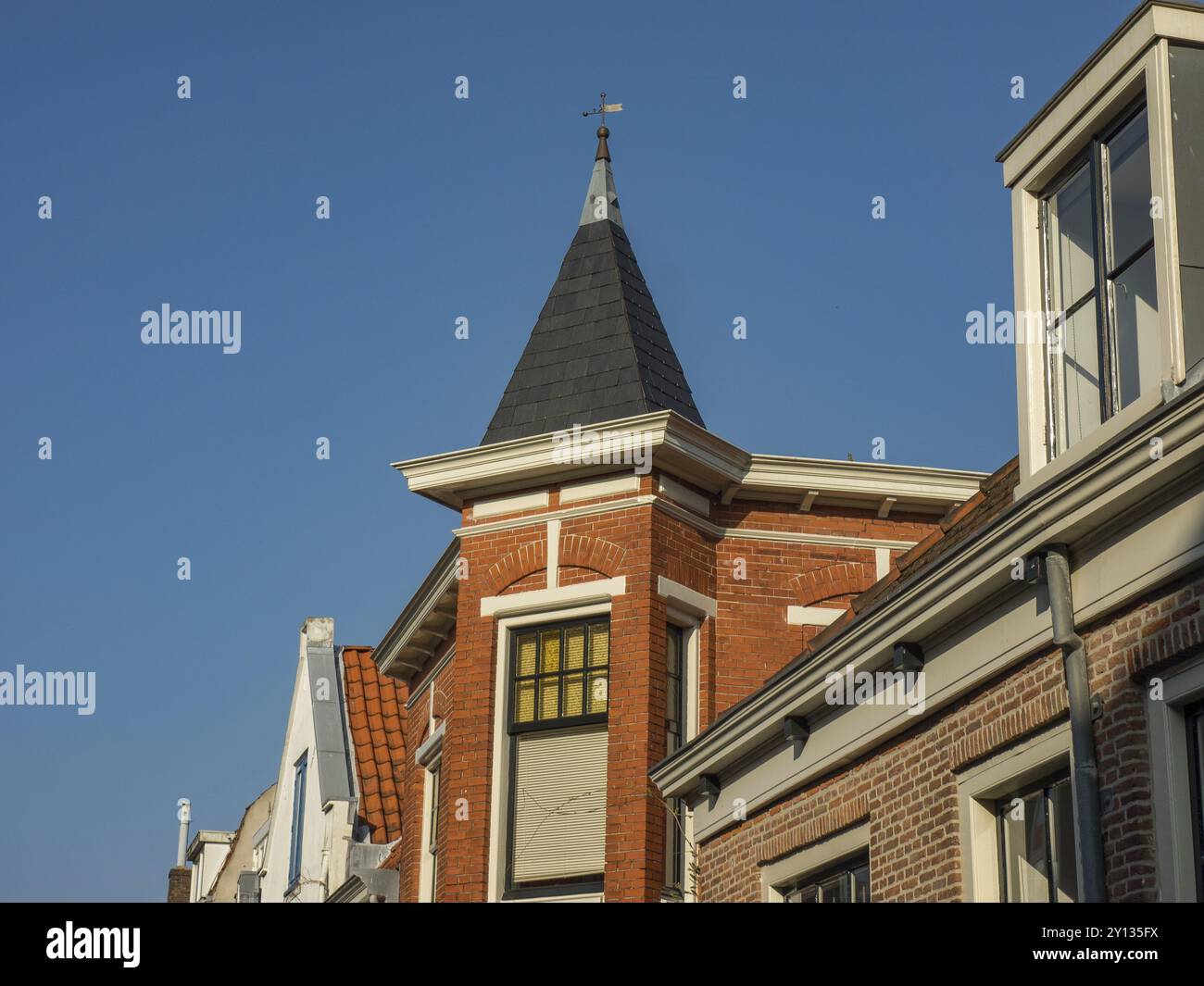Top of the brick house with tower under a clear blue sky, Haarlem ...
