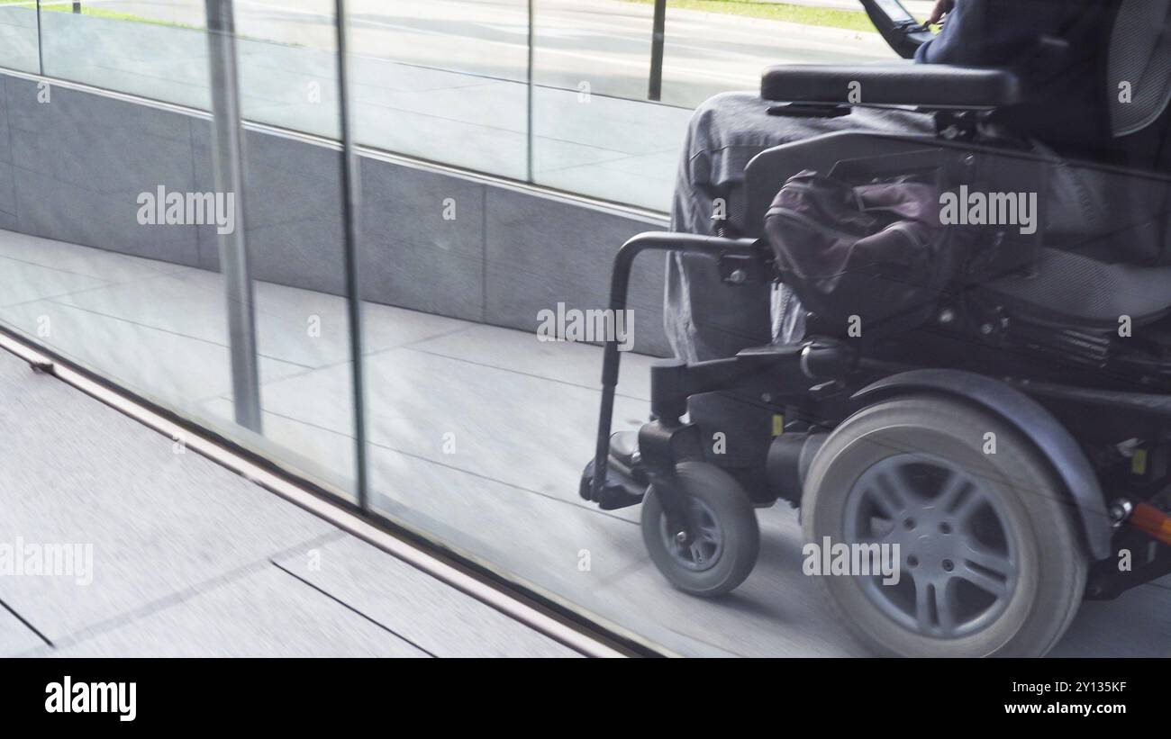Man on electric wheelchair using a ramp. Accessibility concept Stock ...