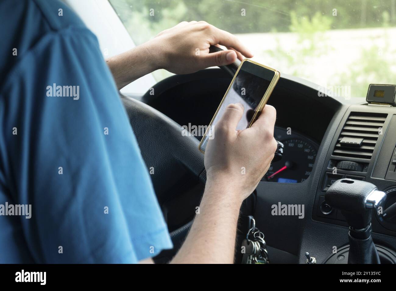 Photo of a man using smartphone while driving the car, transportation ...