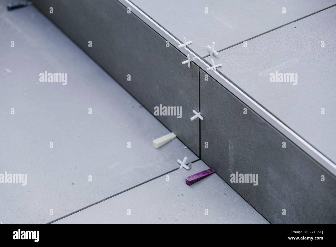 Laying new tiles on a concrete steps outside of a building Stock Photo ...