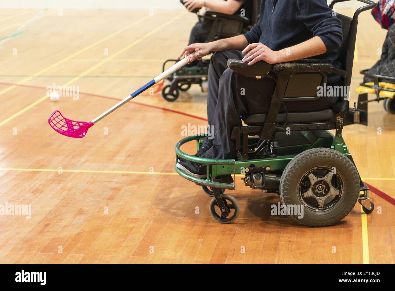 Photo of disabled man on a wheelchair playing sports, hockey ...