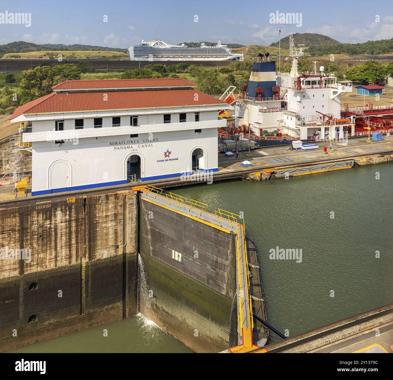 Lock system with a ship and a building. Calm water and clear sky with ...