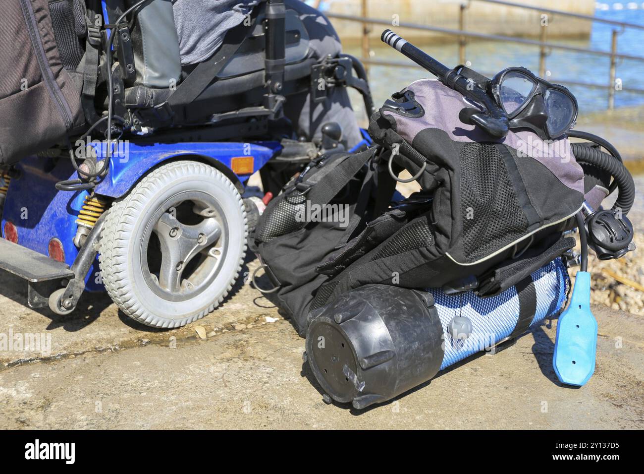 Handicapped disabled scuba diver with equipment on a beach shore ...
