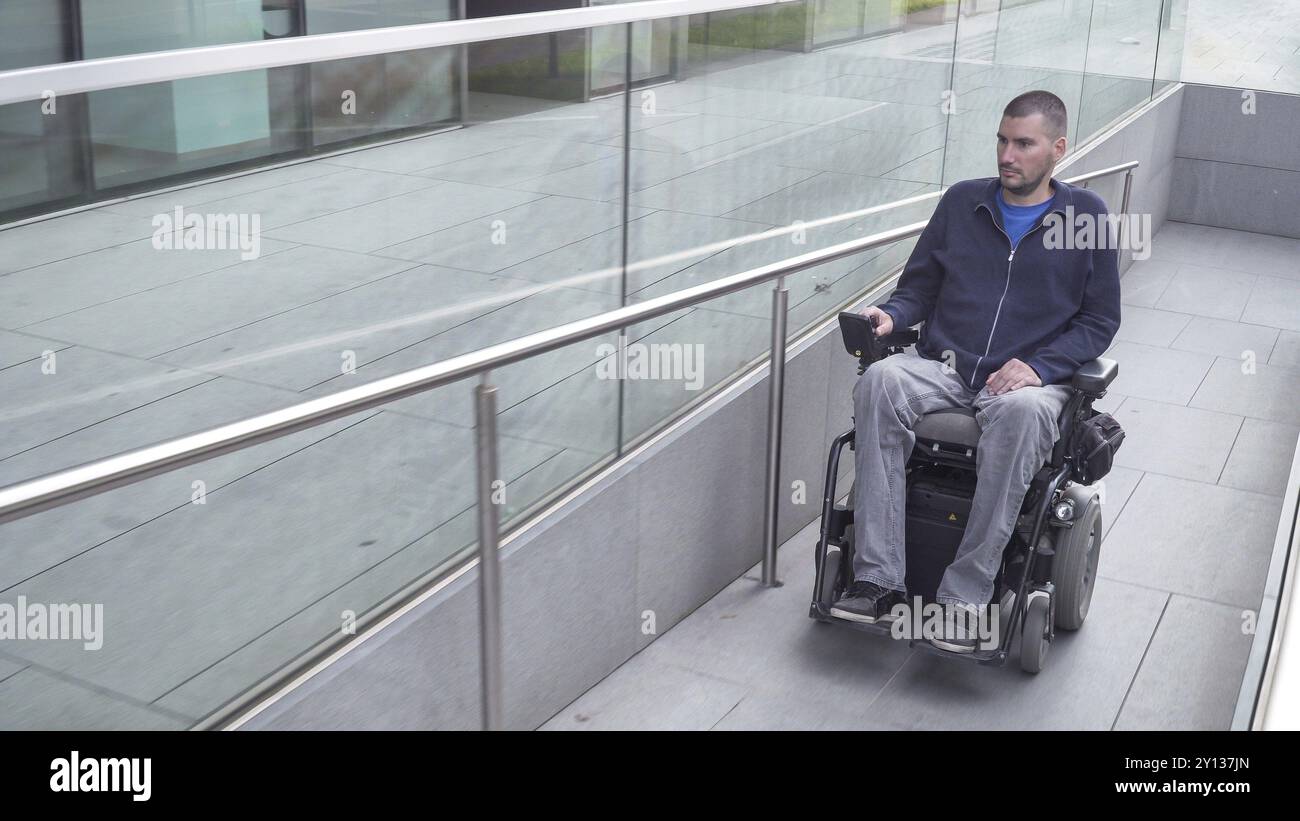 Man on electric wheelchair using a ramp. Accessibility concept Stock ...