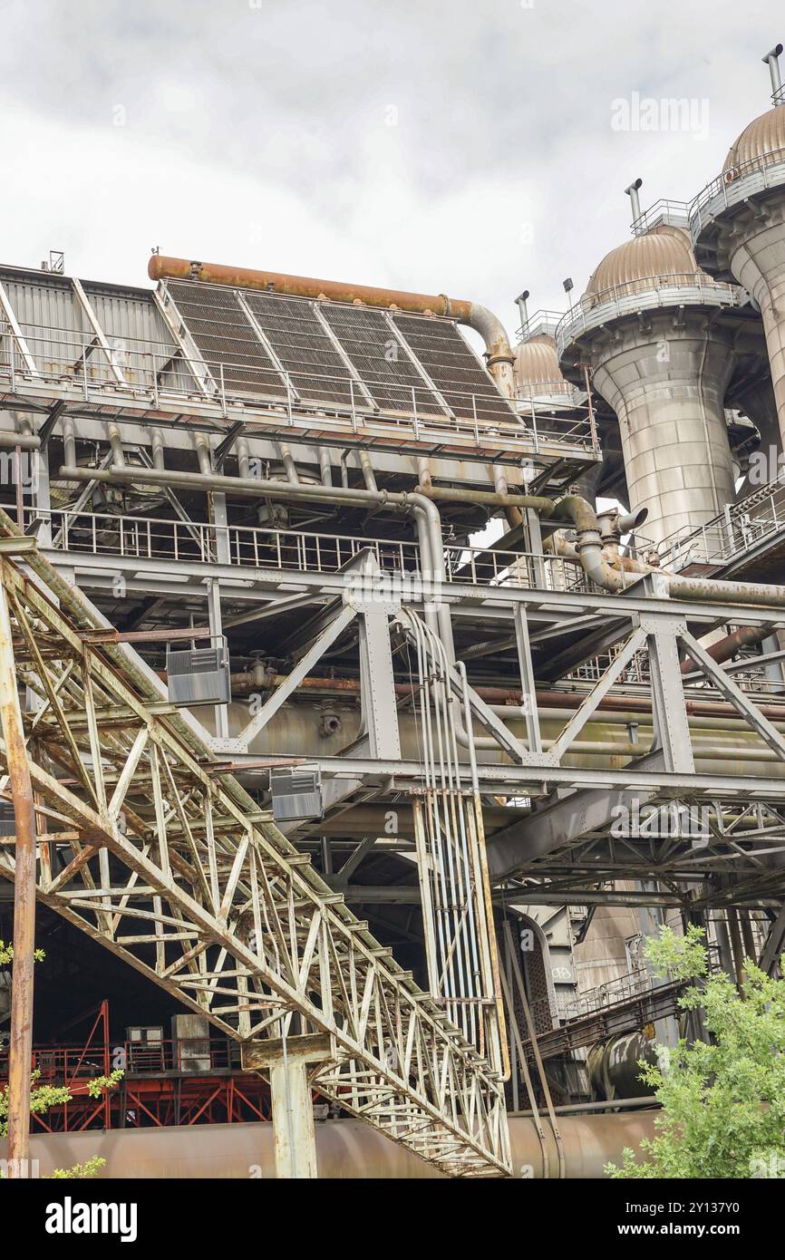 Complex metal structure of an industrial plant with stairs and pipes ...
