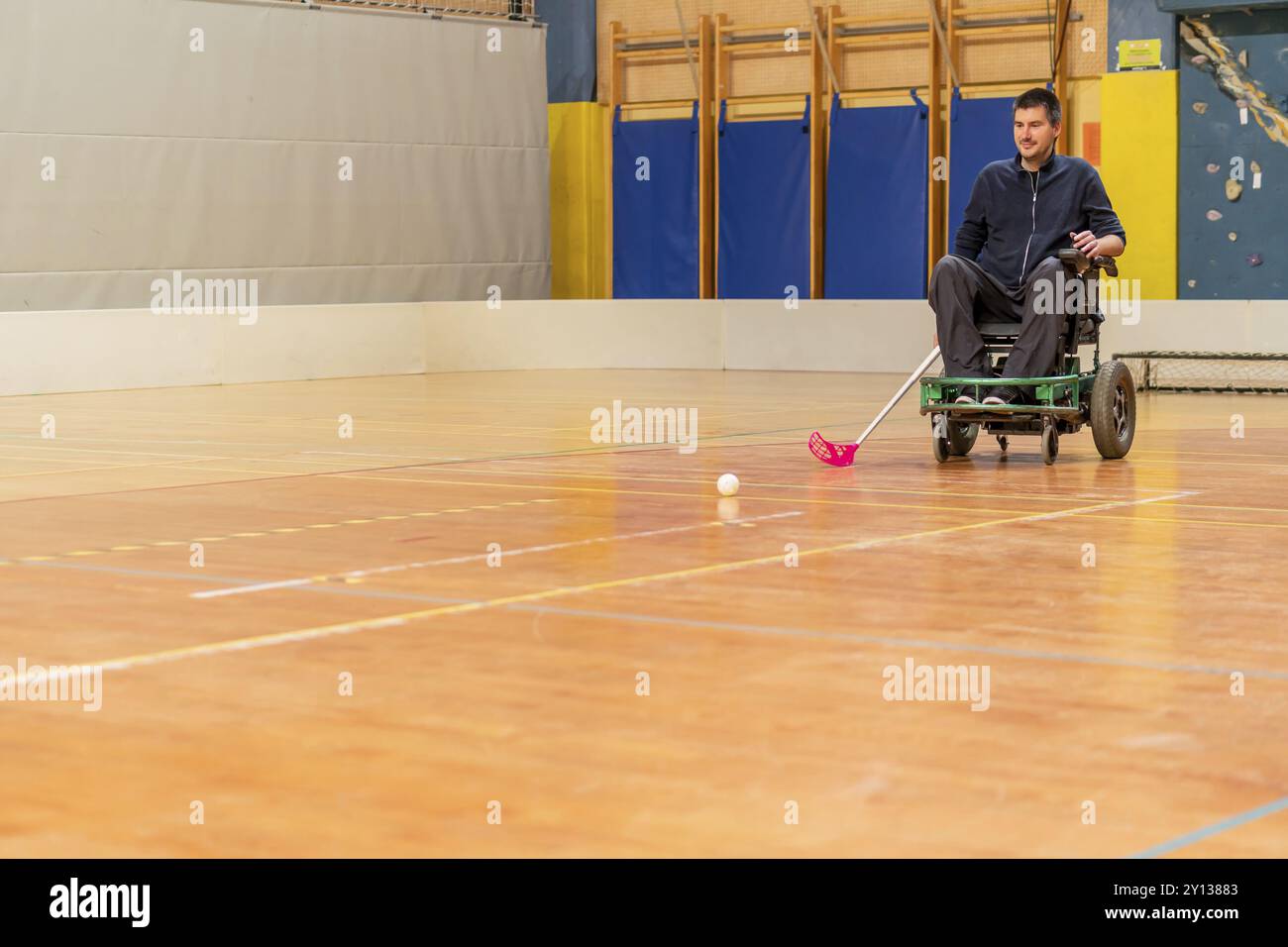 Photo of disabled man on a wheelchair playing sports, hockey ...