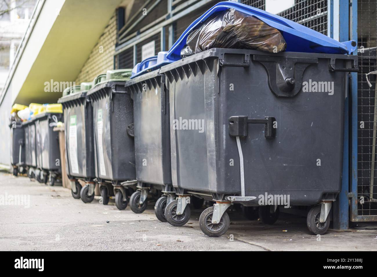 Overflowing garbage bins with household waste in the city Stock Photo ...