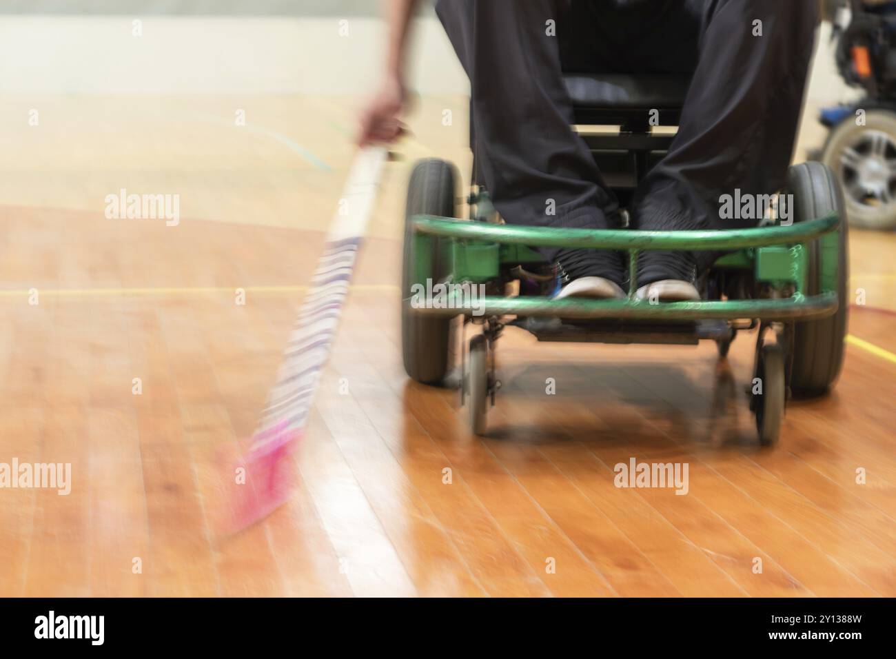 Photo of disabled man on a wheelchair playing sports, hockey ...