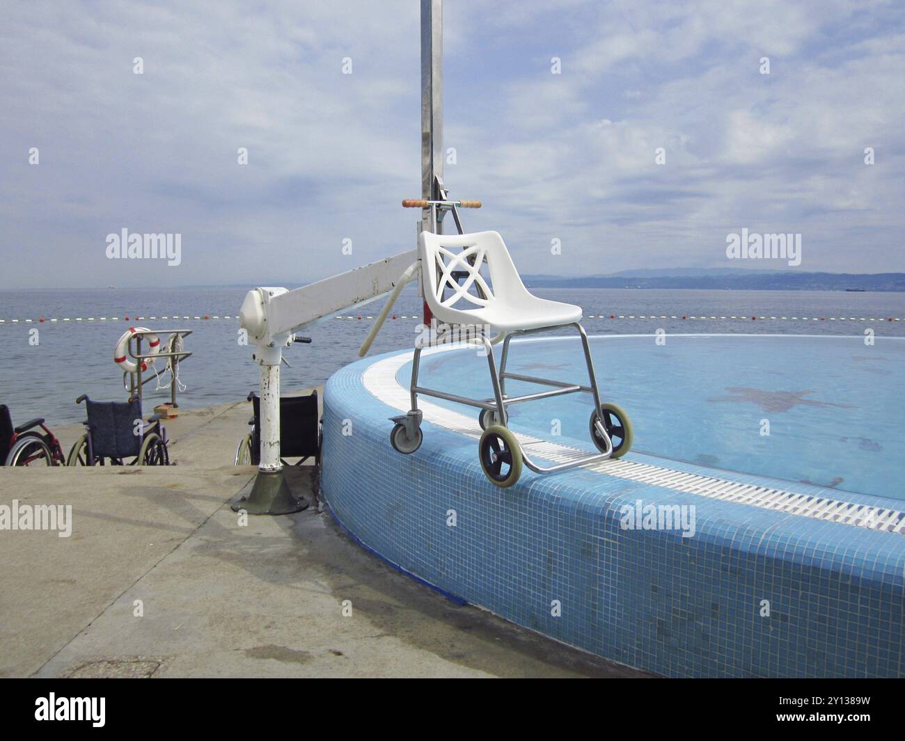 Adapted beach and pool with lift for disabled swimmers Stock Photo - Alamy