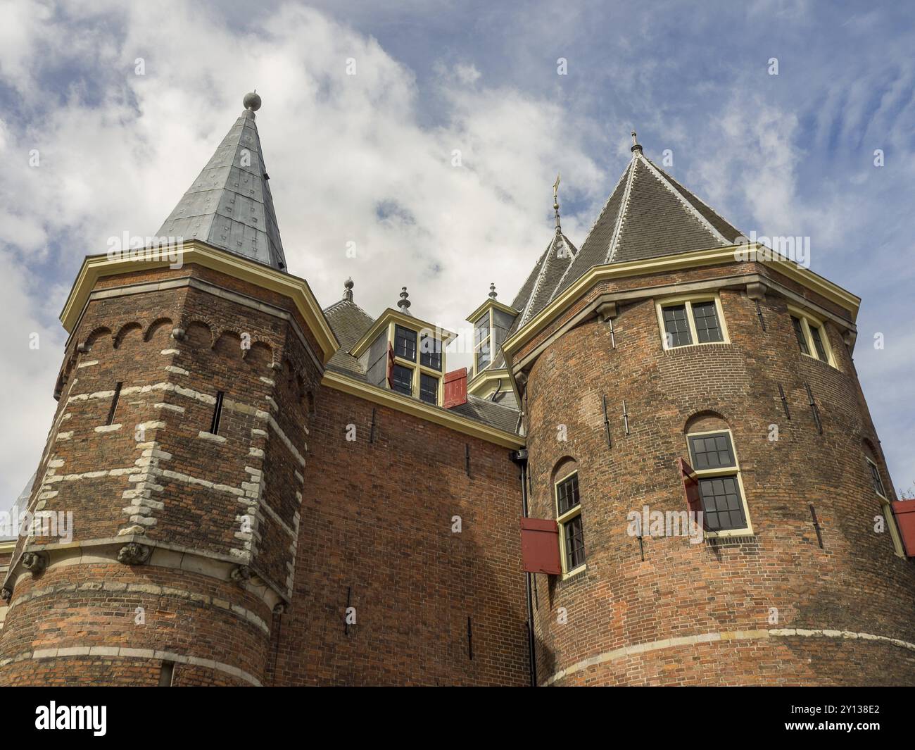 Side view of a medieval building with bricks and towers against a ...