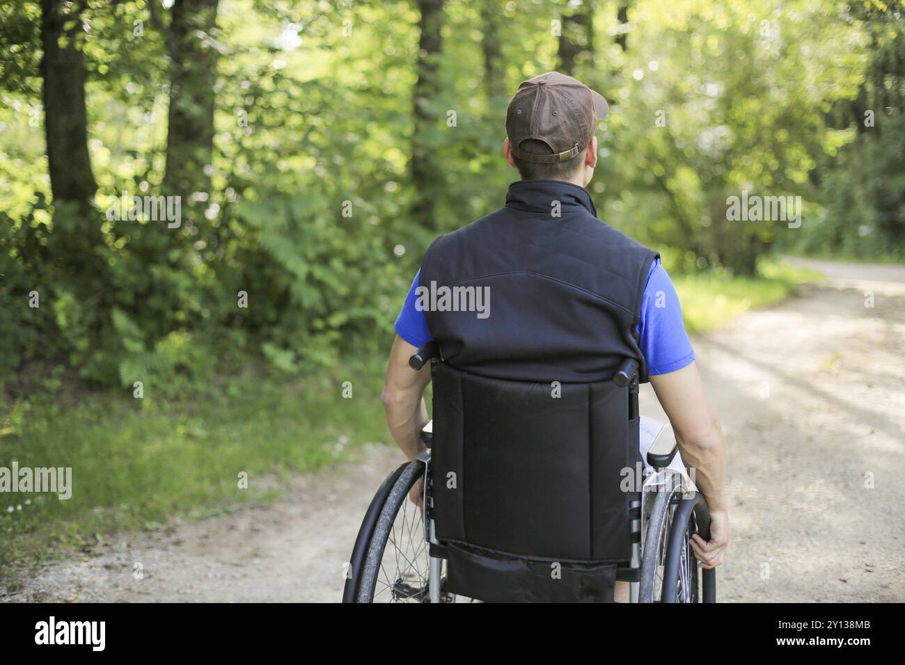 Happy and young disabled or handicapped man sitting on a wheelchair in ...