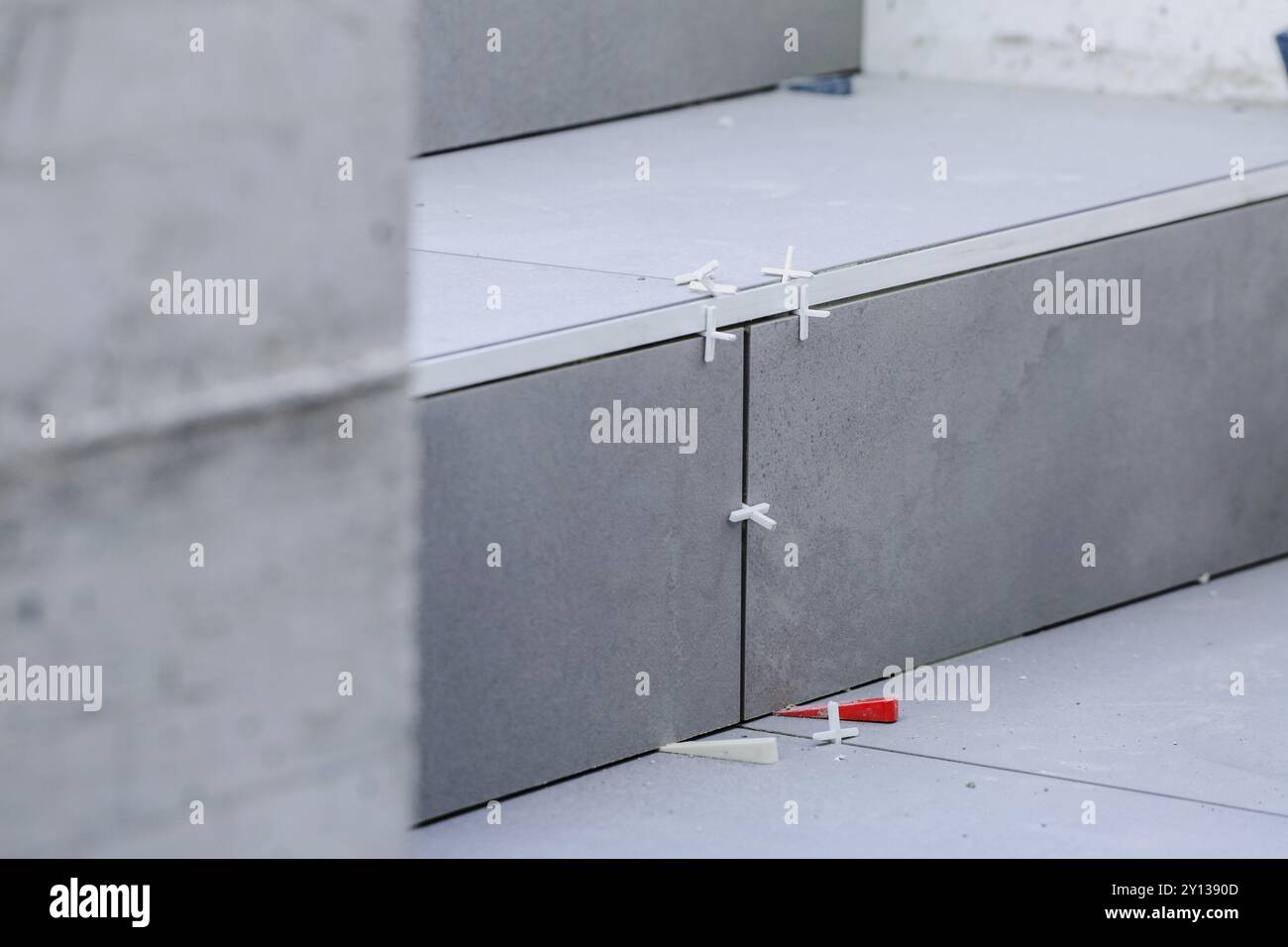 Laying new tiles on a concrete steps outside of a building Stock Photo ...
