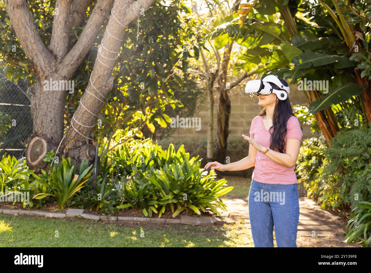 Using VR headset, asian woman exploring virtual reality in outdoor ...