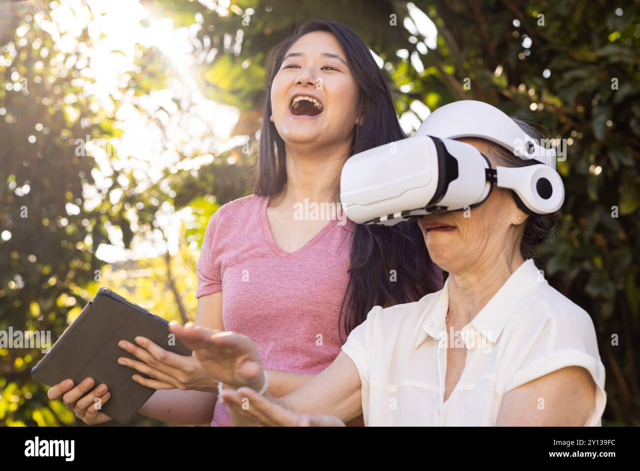 Using VR headset, asian grandmother exploring virtual reality, daughter ...