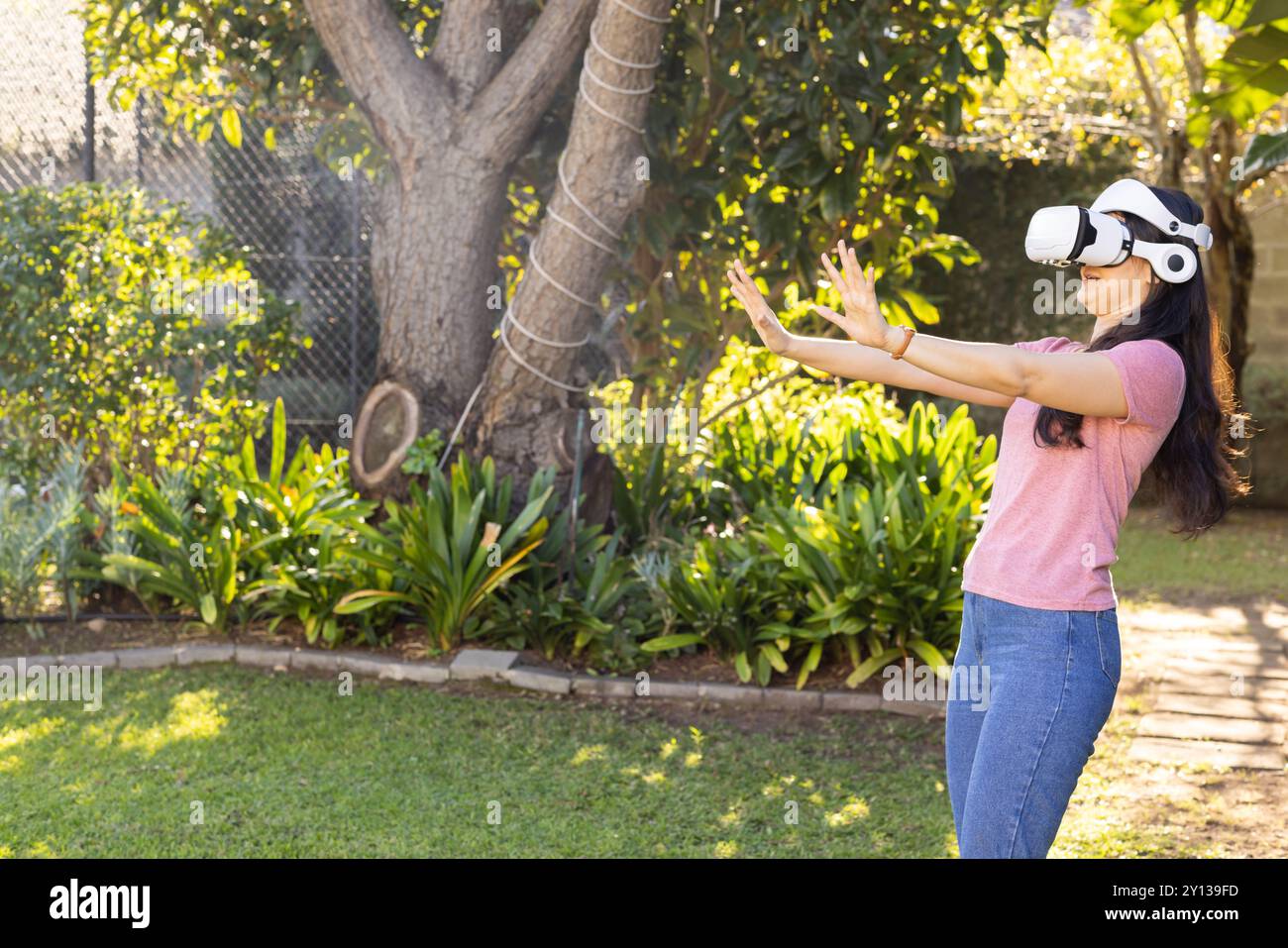 Using VR headset, asian woman exploring virtual reality in outdoor ...