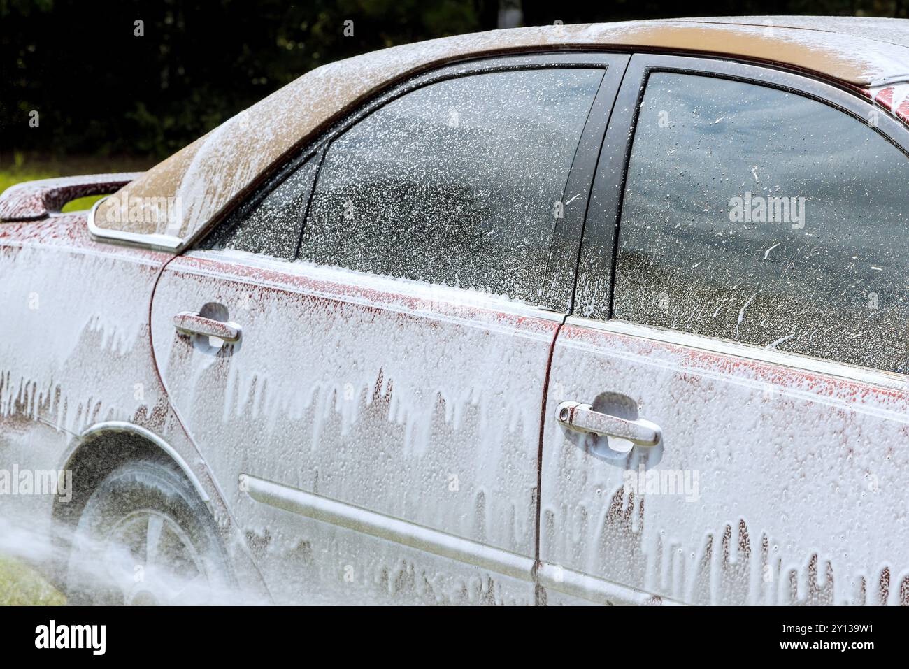 Washing car with high pressure foam under pressure is self service ...
