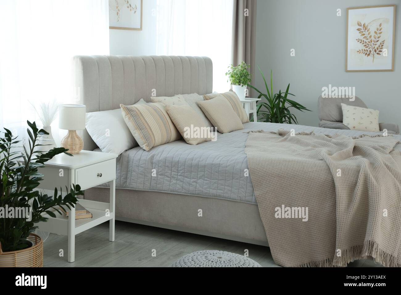 Big comfortable bed in room. Interior design Stock Photo - Alamy