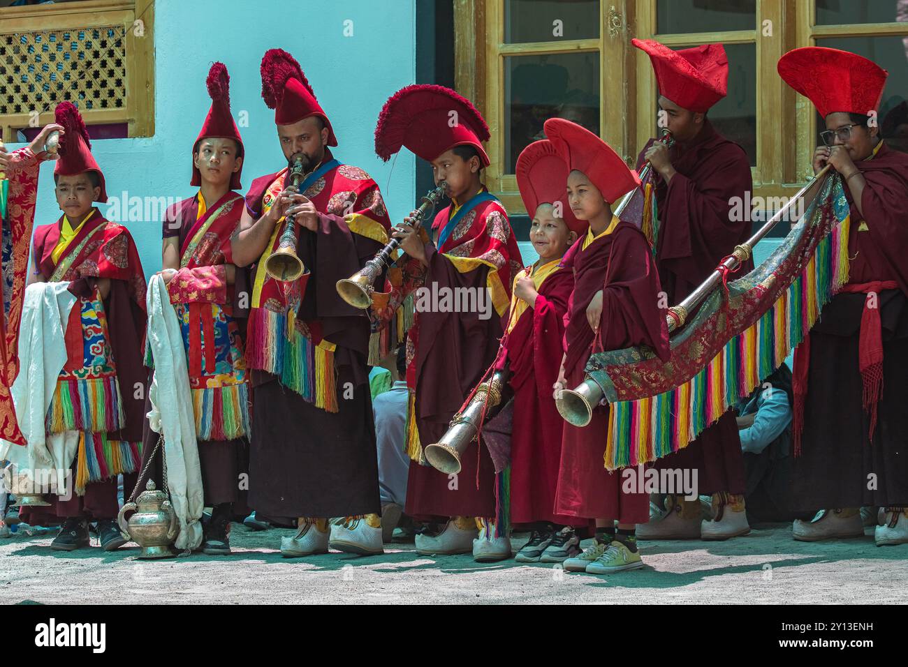 Ladakhi monks wearing traditional outfits and playing musical ...