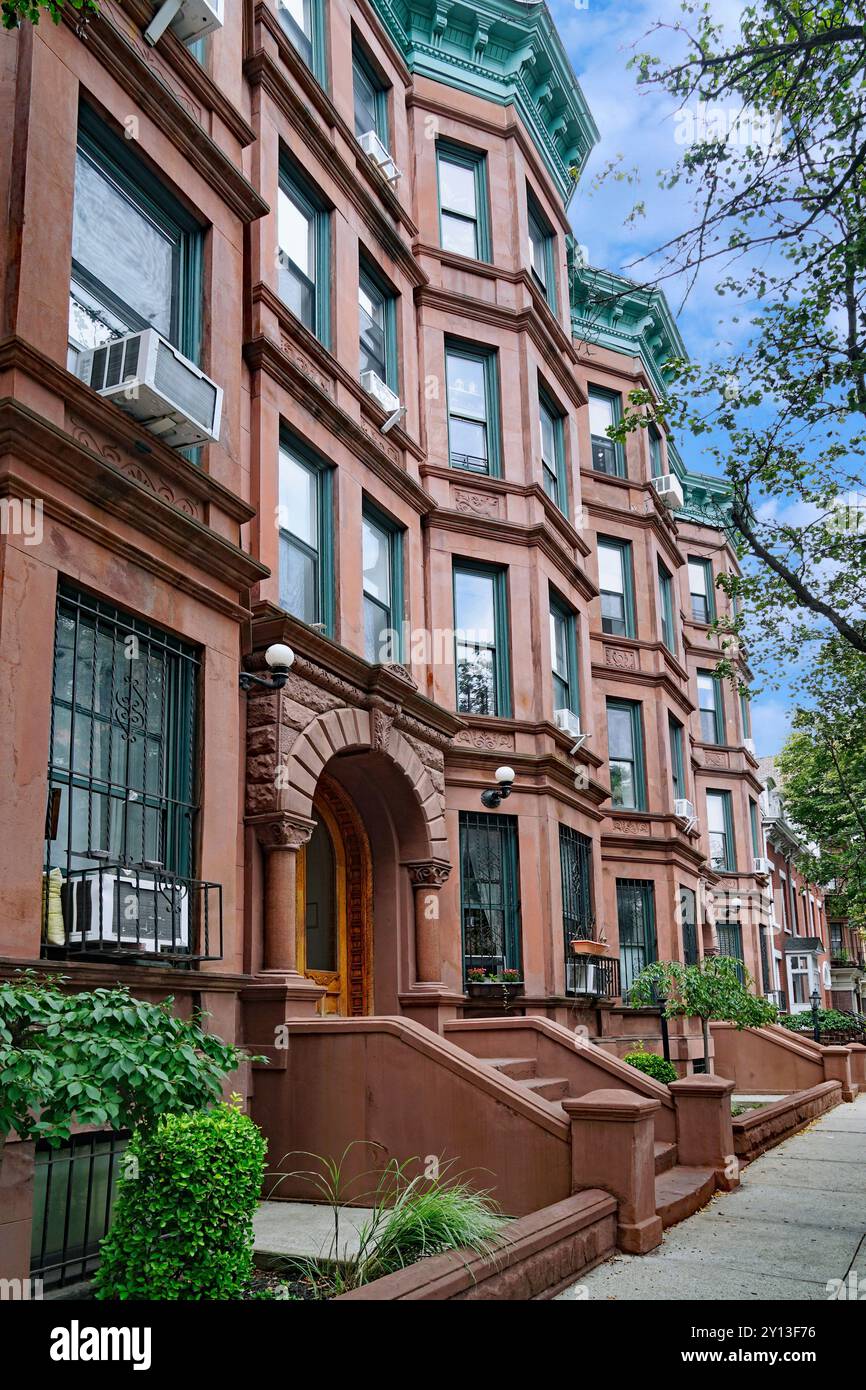 New York City, row of old brownstone townhouses with bay windows Stock ...