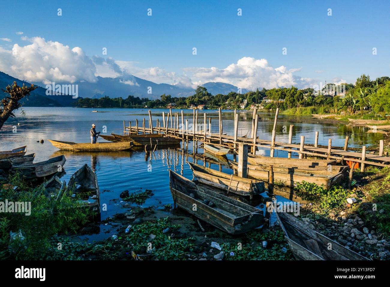 Canoes stranded on Lake Atitlan in front of the San Pedro volcano ...
