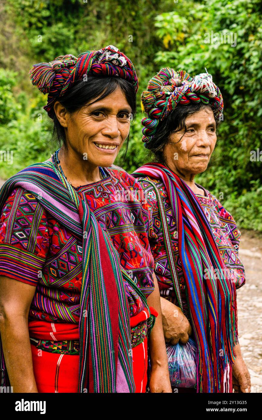 Women in indigenous costume and Queqchi headdress, on the road from La ...