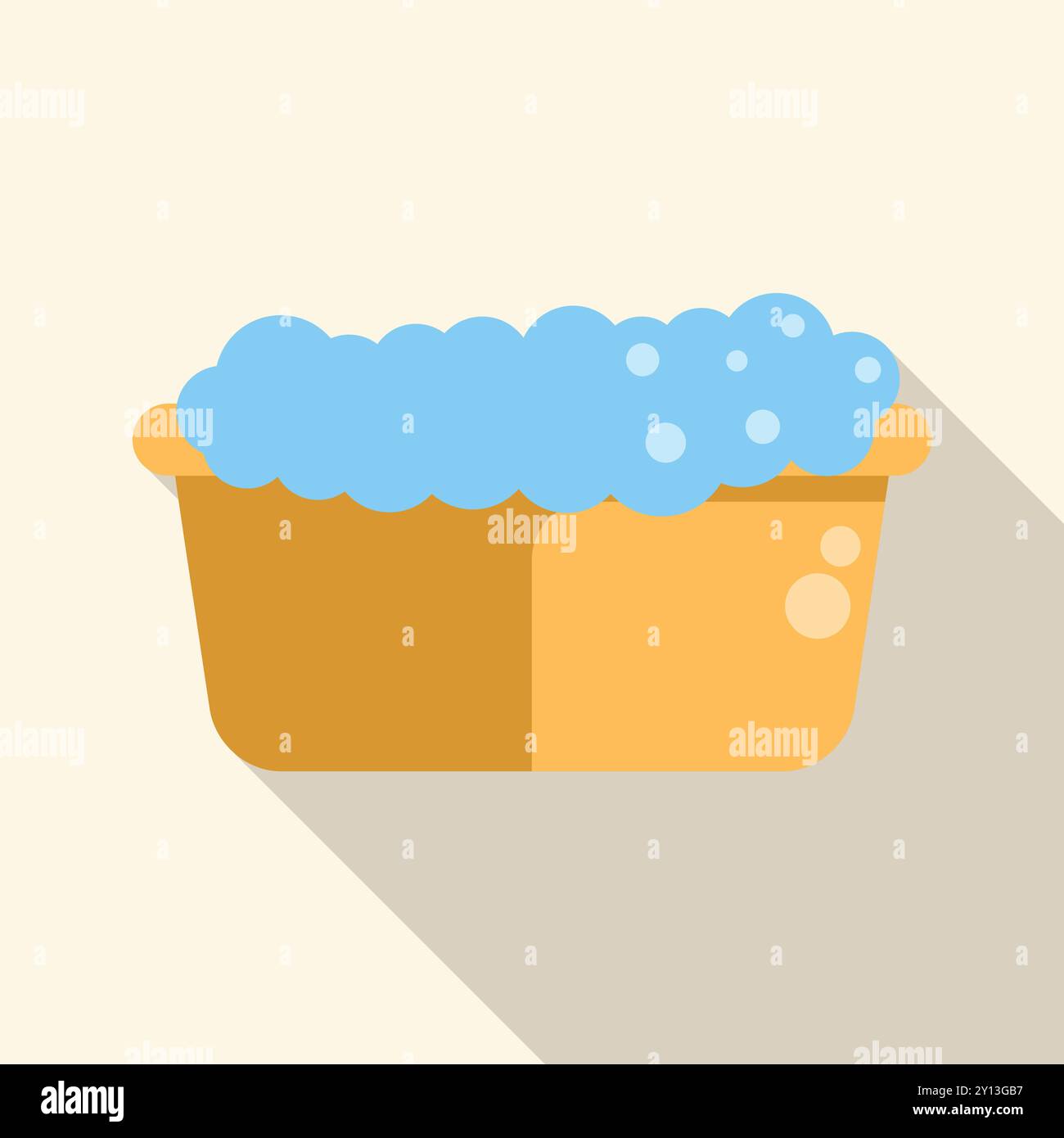 Yellow plastic basin filled with blue soapy water for laundry washing ...