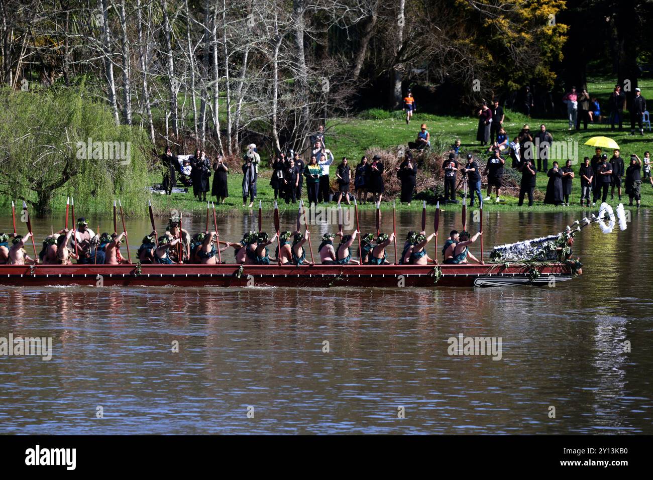 A waka, a traditional canoe, is paddled by warriors as part of the ...