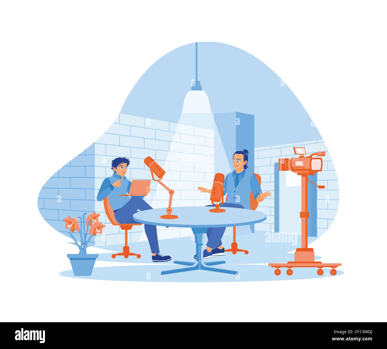 A young male vlogger is making a podcast with a man in the studio ...