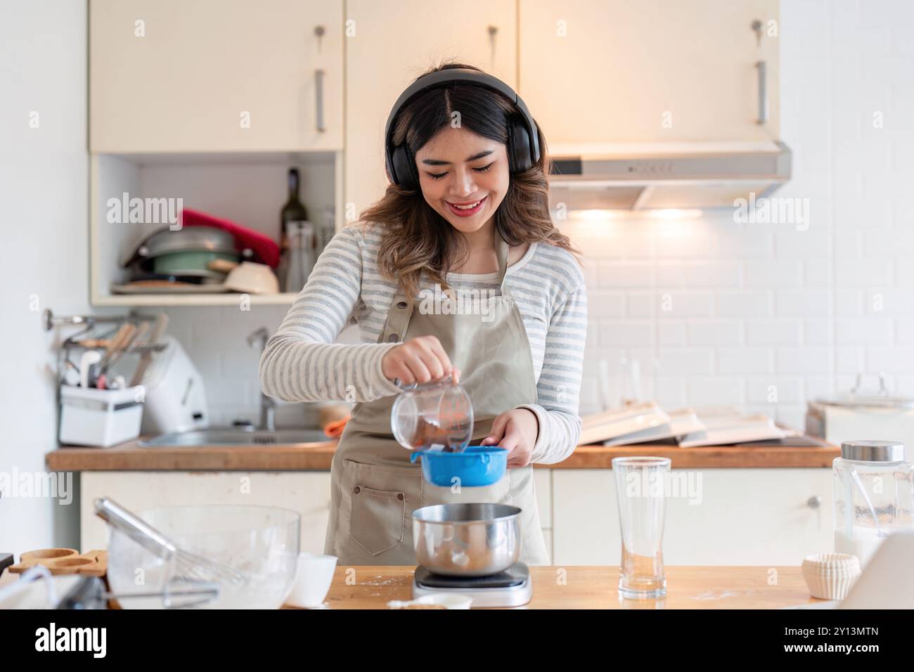 Pouring ingredients with musical inspiration in cozy kitchen Stock ...