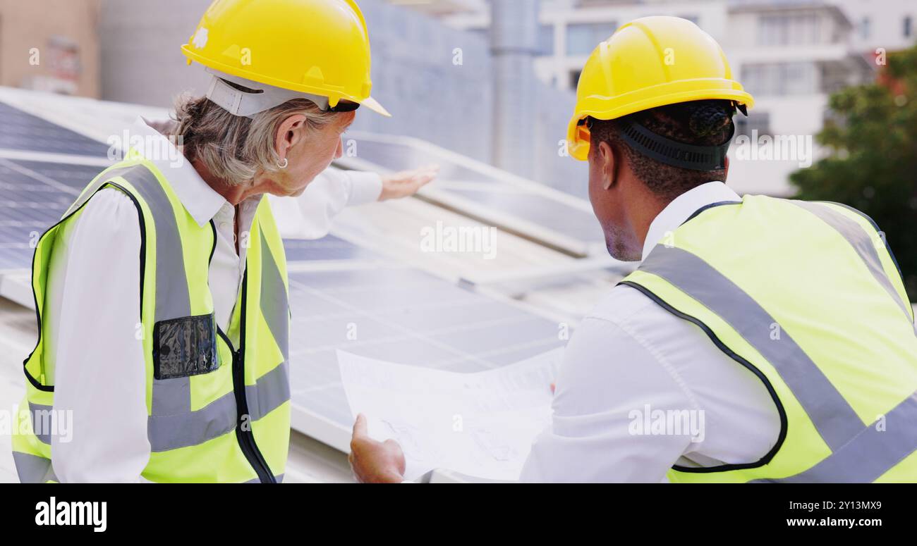 Solar panel, business people and teamwork with blueprint for planning ...