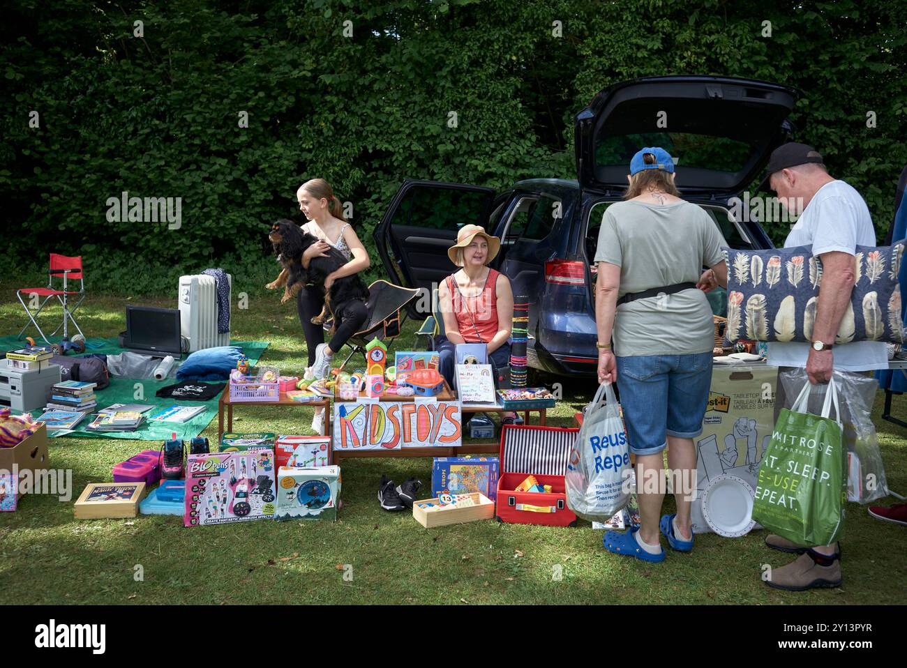 Mother and daugter in front of their car boot stall, Berkshire, UK ...