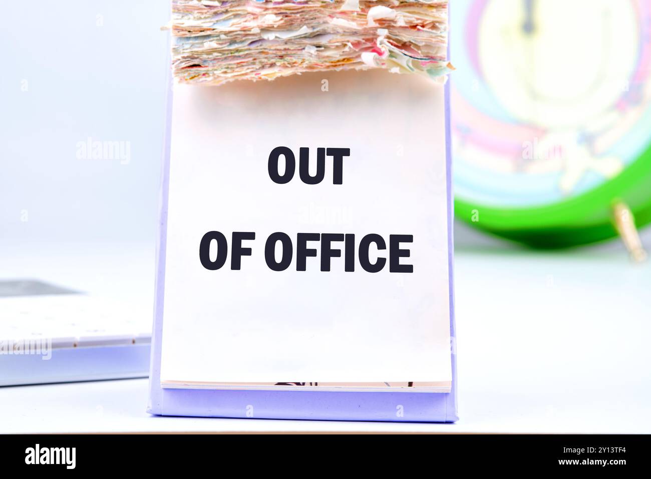 OUT OF OFFICE words written in a desktop calendar on a light background ...