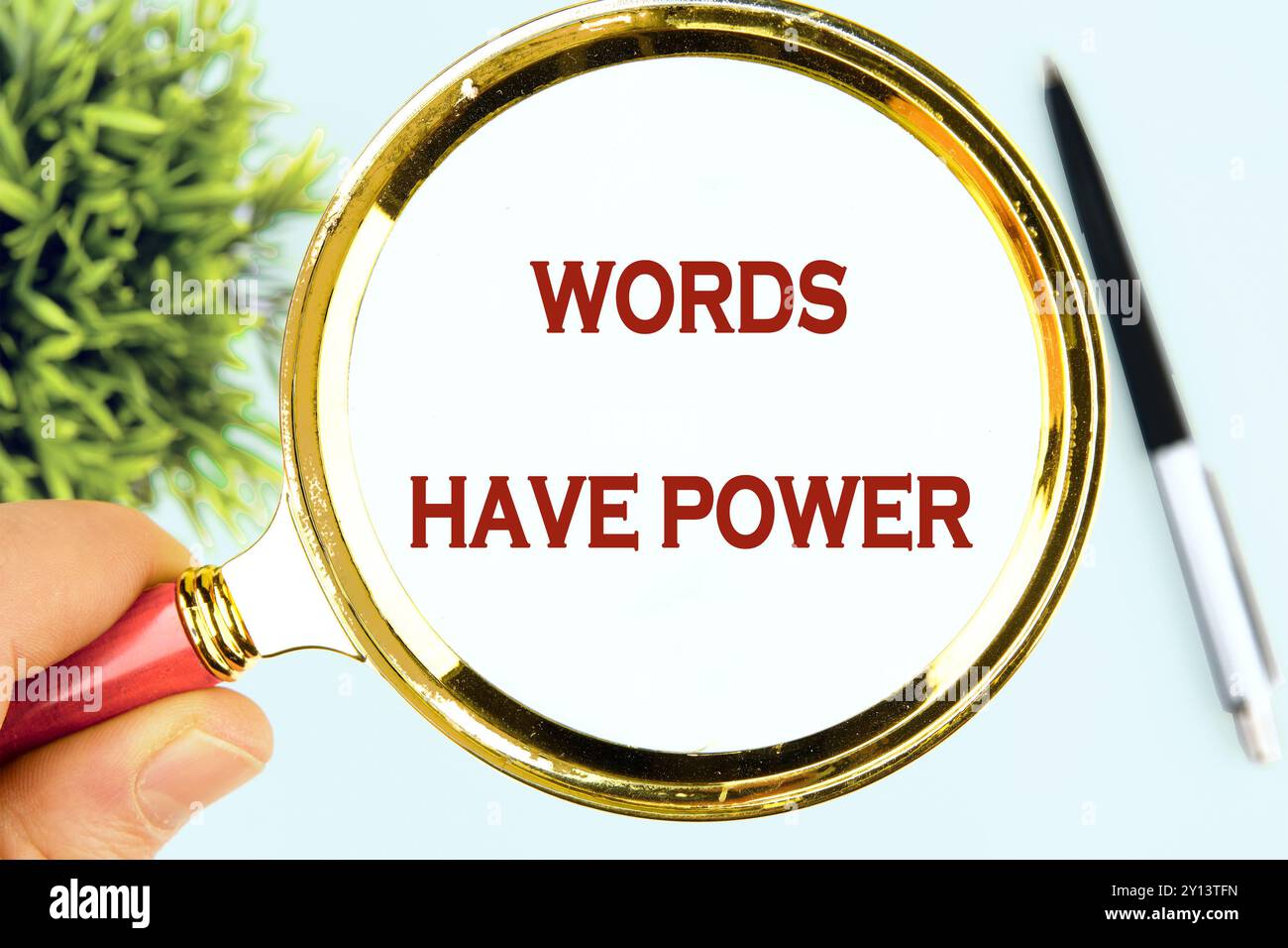 WORDS HAVE POWER TEXT written through a magnifying glass, top view on a ...