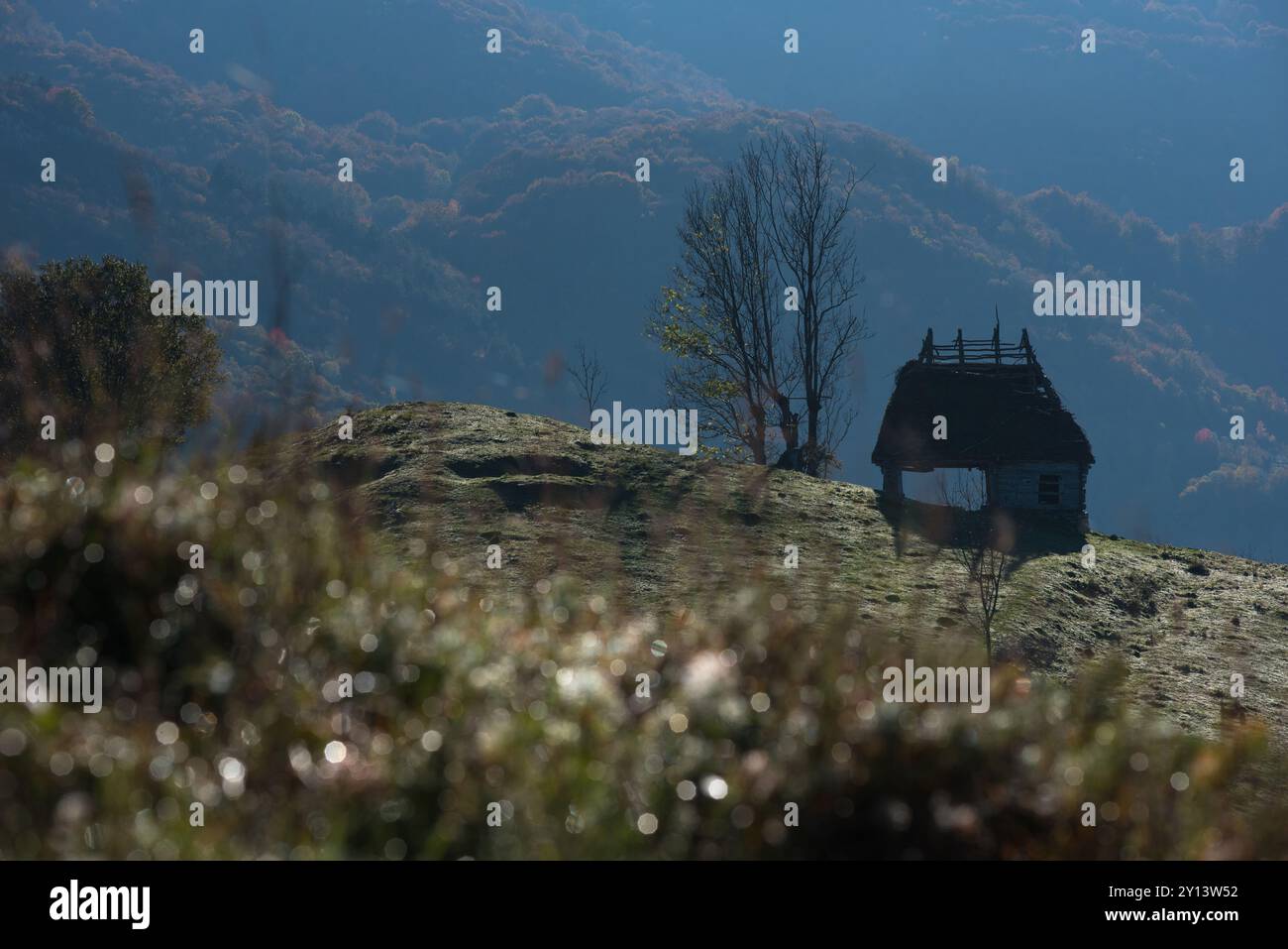 Mountain homestead in the autumn. Countryside thatched roof houses ...